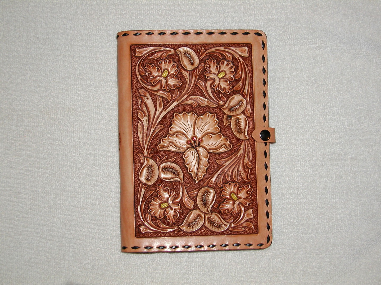 Floral design note pad binder with snap keeper and buck stitch